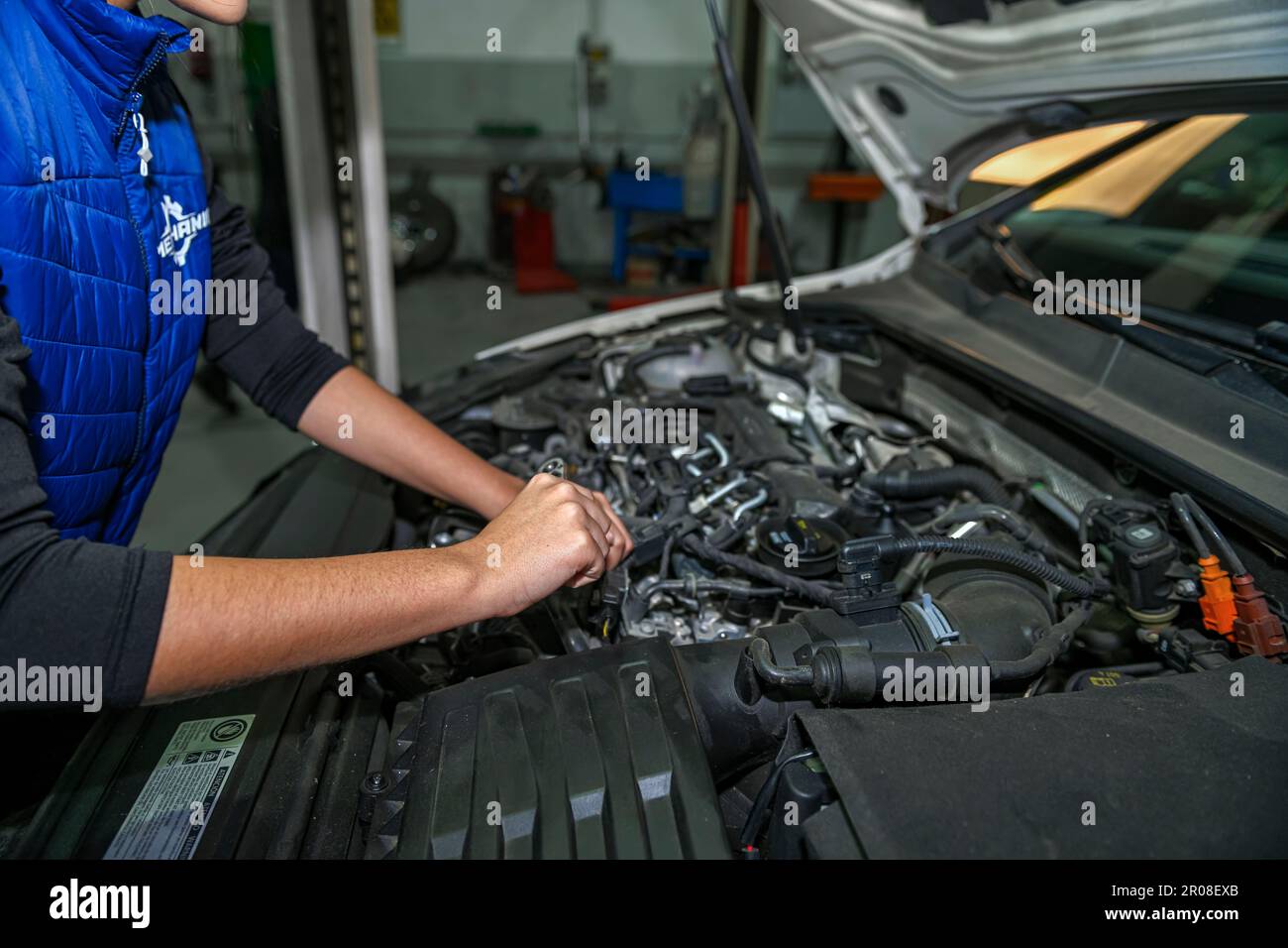 Young female mechanic, working on the repair of a car engine Stock ...