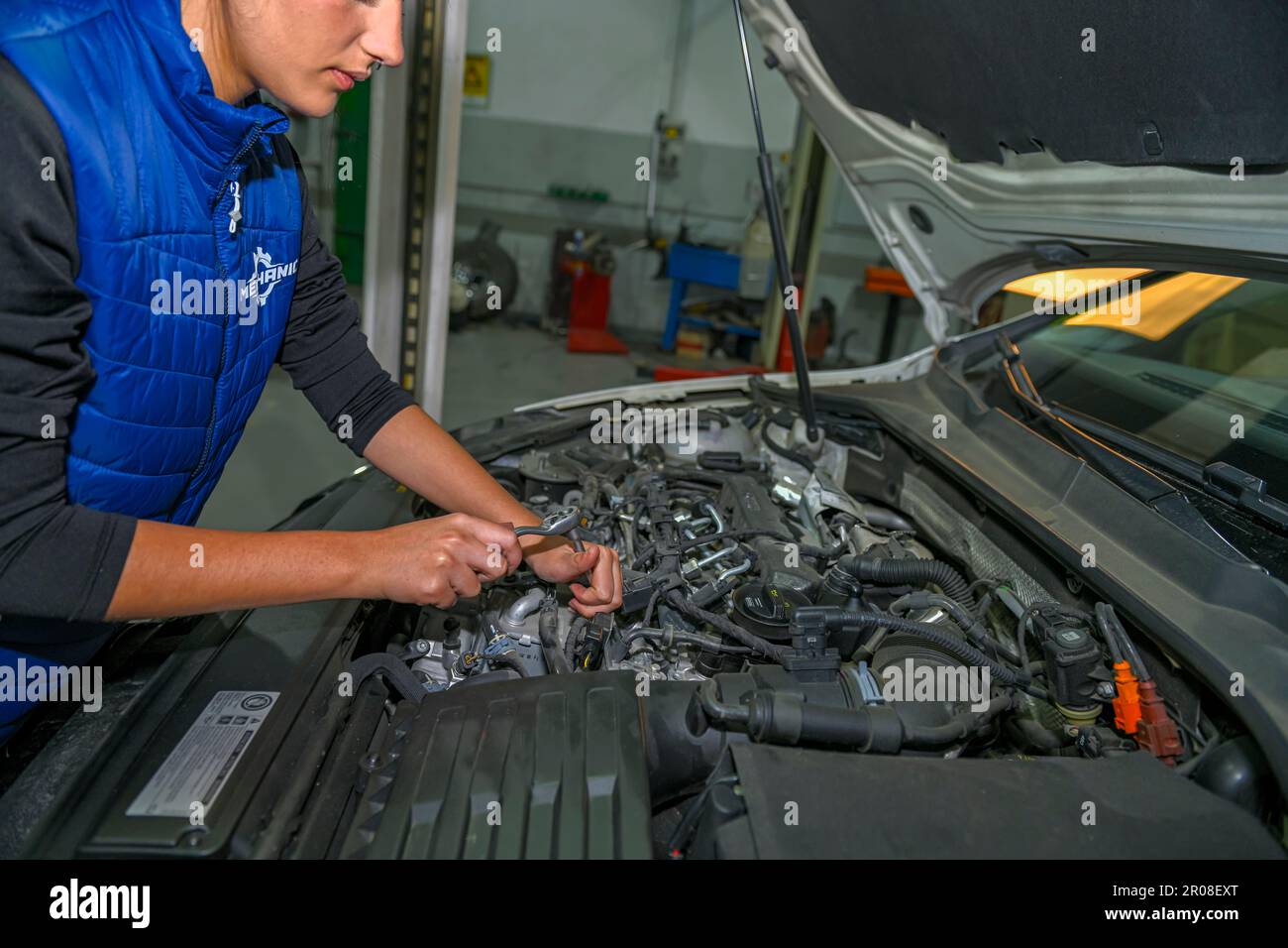 Young female mechanic, working on the repair of a car engine Stock ...