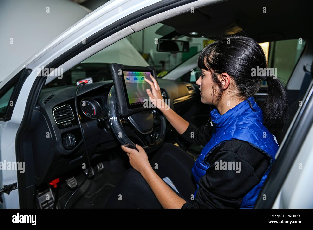 Young female mechanic, working on the repair of a car engine Stock ...