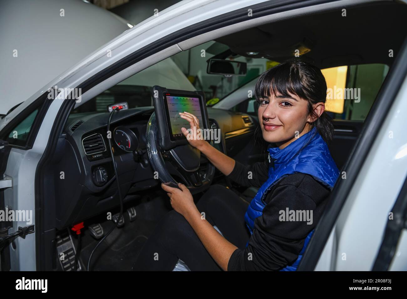 Young female mechanic, working on the repair of a car engine Stock ...