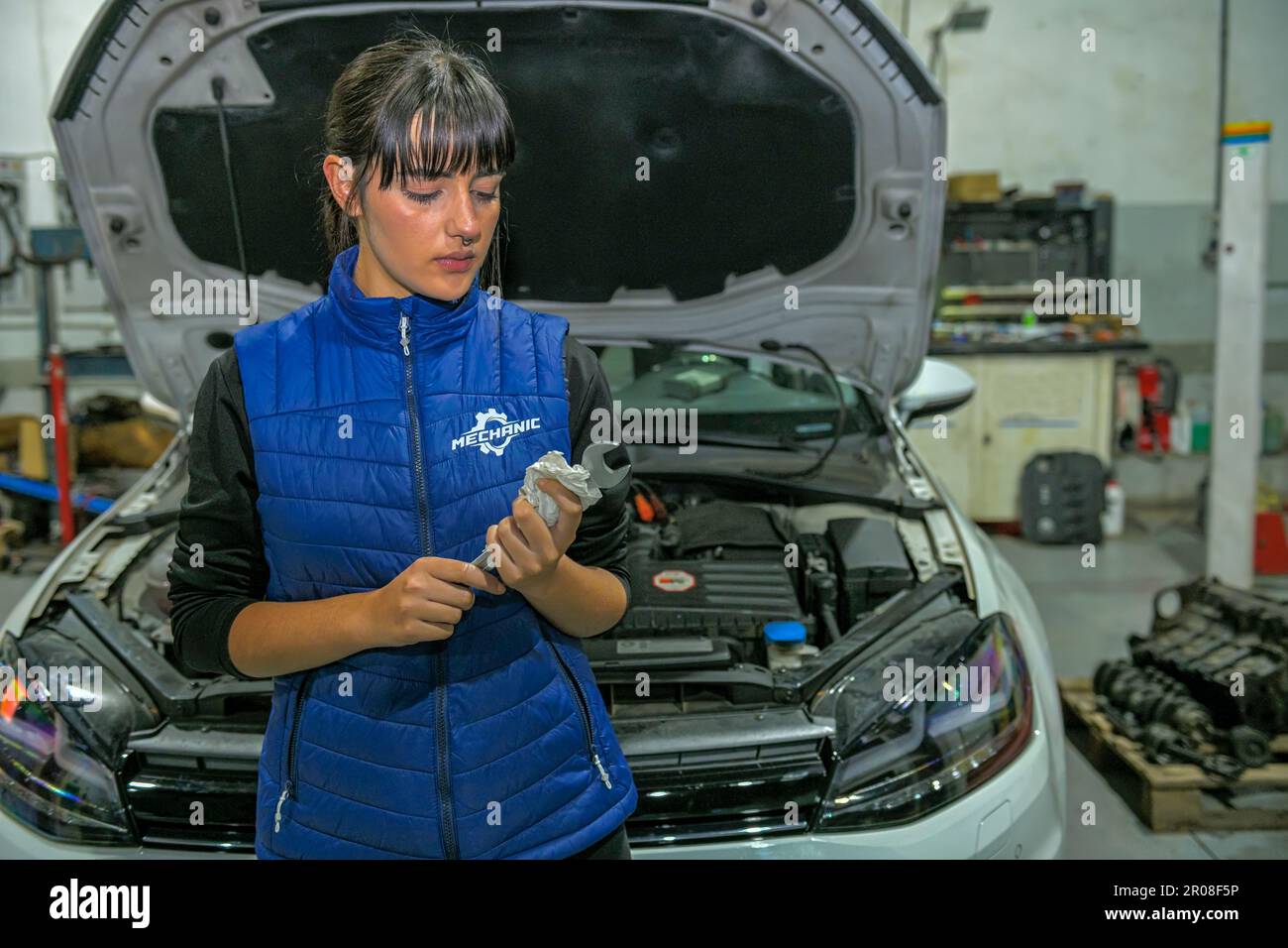 Young female mechanic, working on the repair of a car engine Stock ...