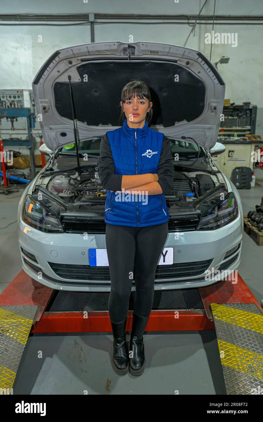Young female mechanic, working on the repair of a car engine Stock ...
