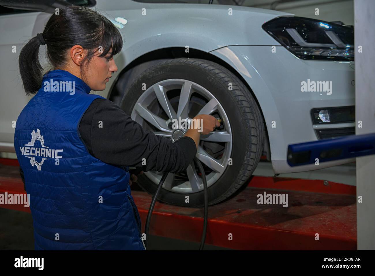 Young female mechanic, working on the repair of a car engine Stock ...