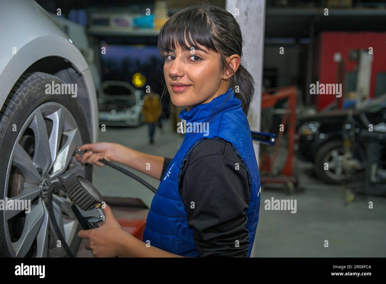 Young female mechanic, working on the repair of a car engine Stock ...