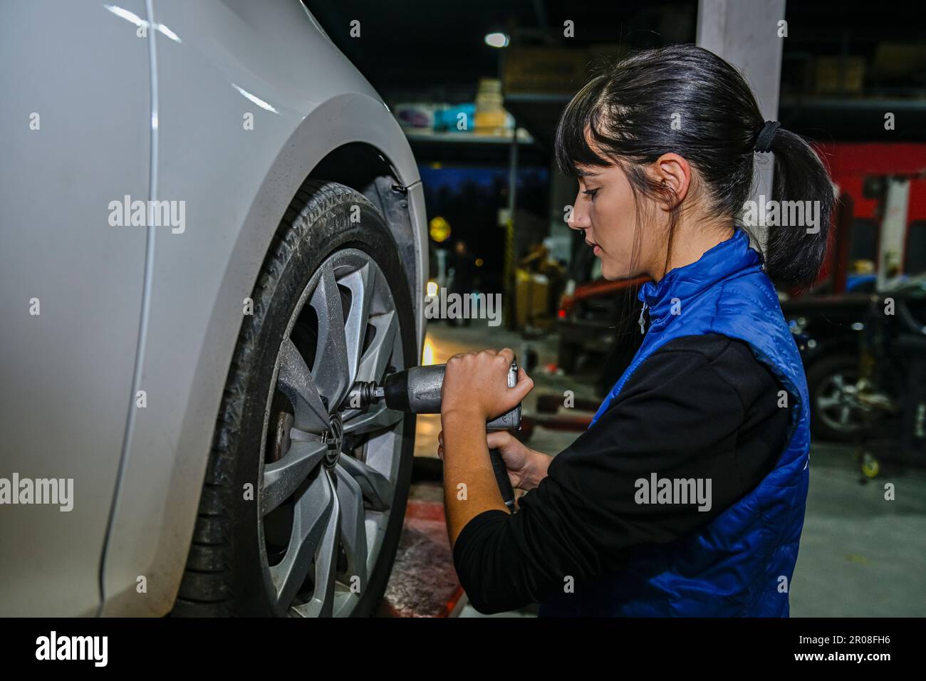 Young female mechanic, working on the repair of a car engine Stock ...
