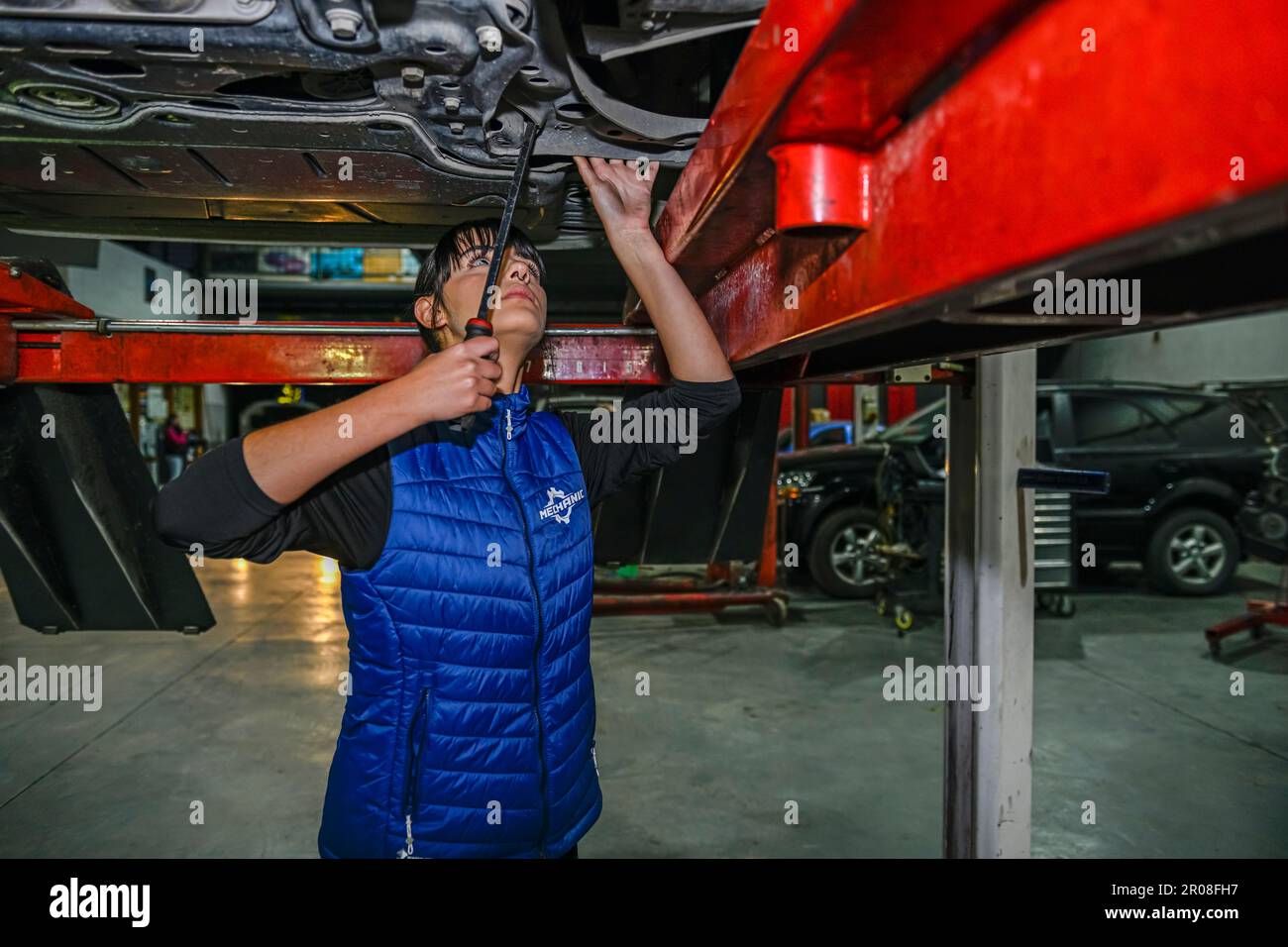 Young female mechanic, working on the repair of a car engine Stock ...