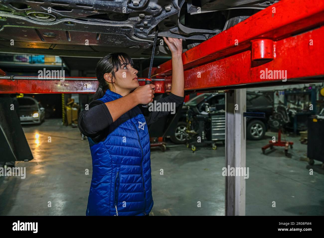 Young female mechanic, working on the repair of a car engine Stock ...