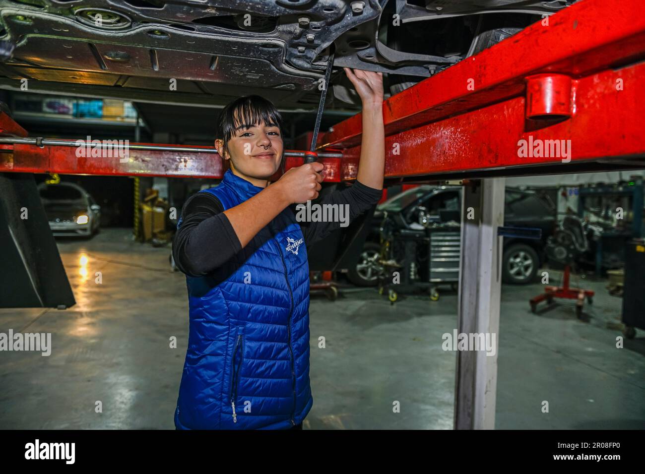 Young female mechanic, working on the repair of a car engine Stock ...