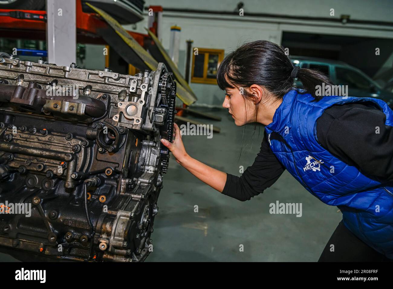 Young female mechanic, working on the repair of a car engine Stock ...