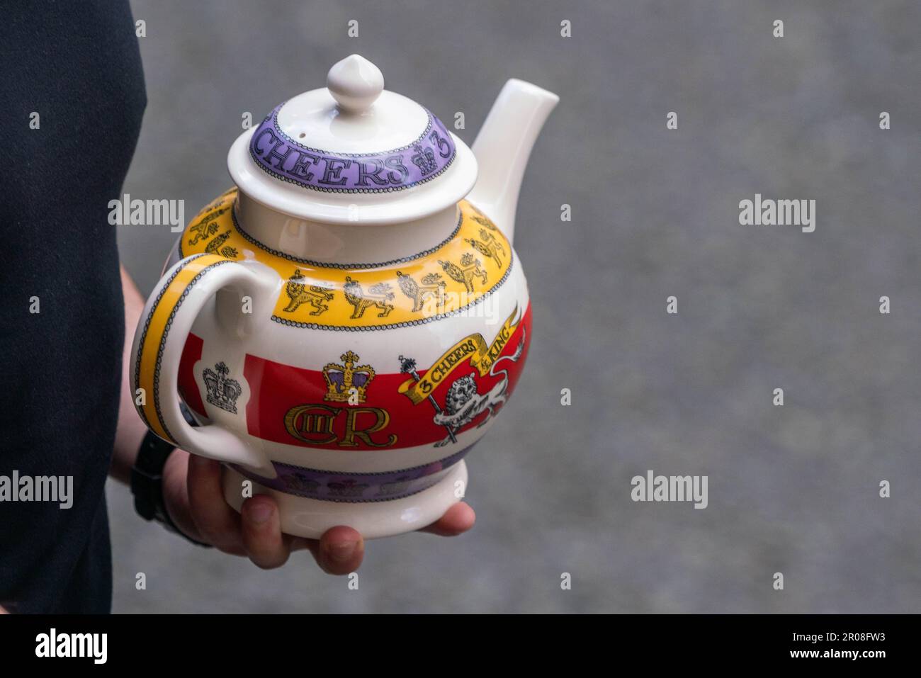 London UK. 7 May 2023. A staff member carries a coronation tea pot as ...