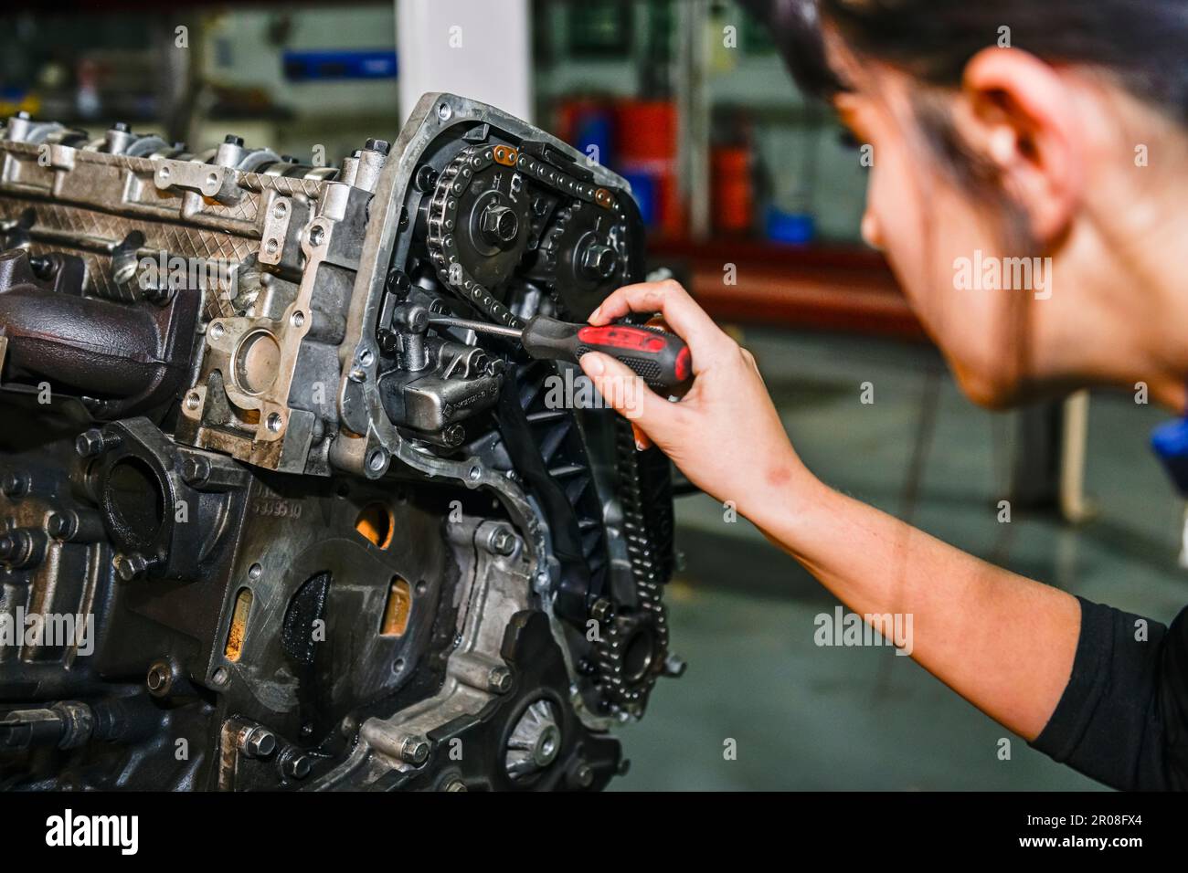 Young female mechanic, working on the repair of a car engine Stock ...