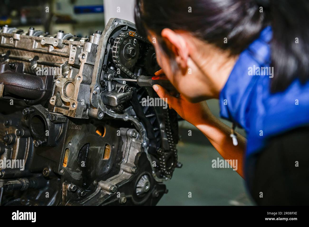 Young female mechanic, working on the repair of a car engine Stock ...