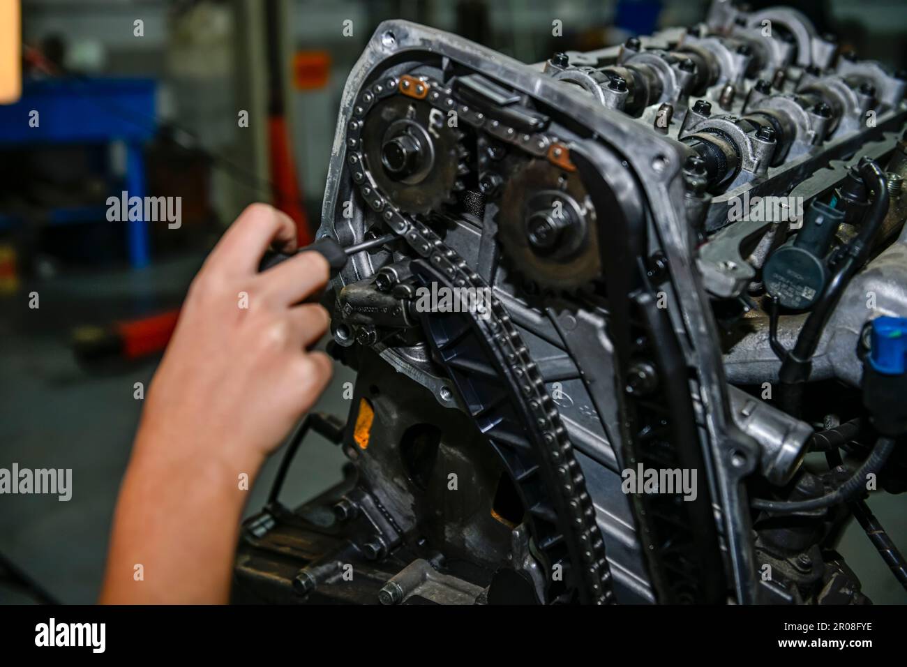 Young female mechanic, working on the repair of a car engine Stock ...
