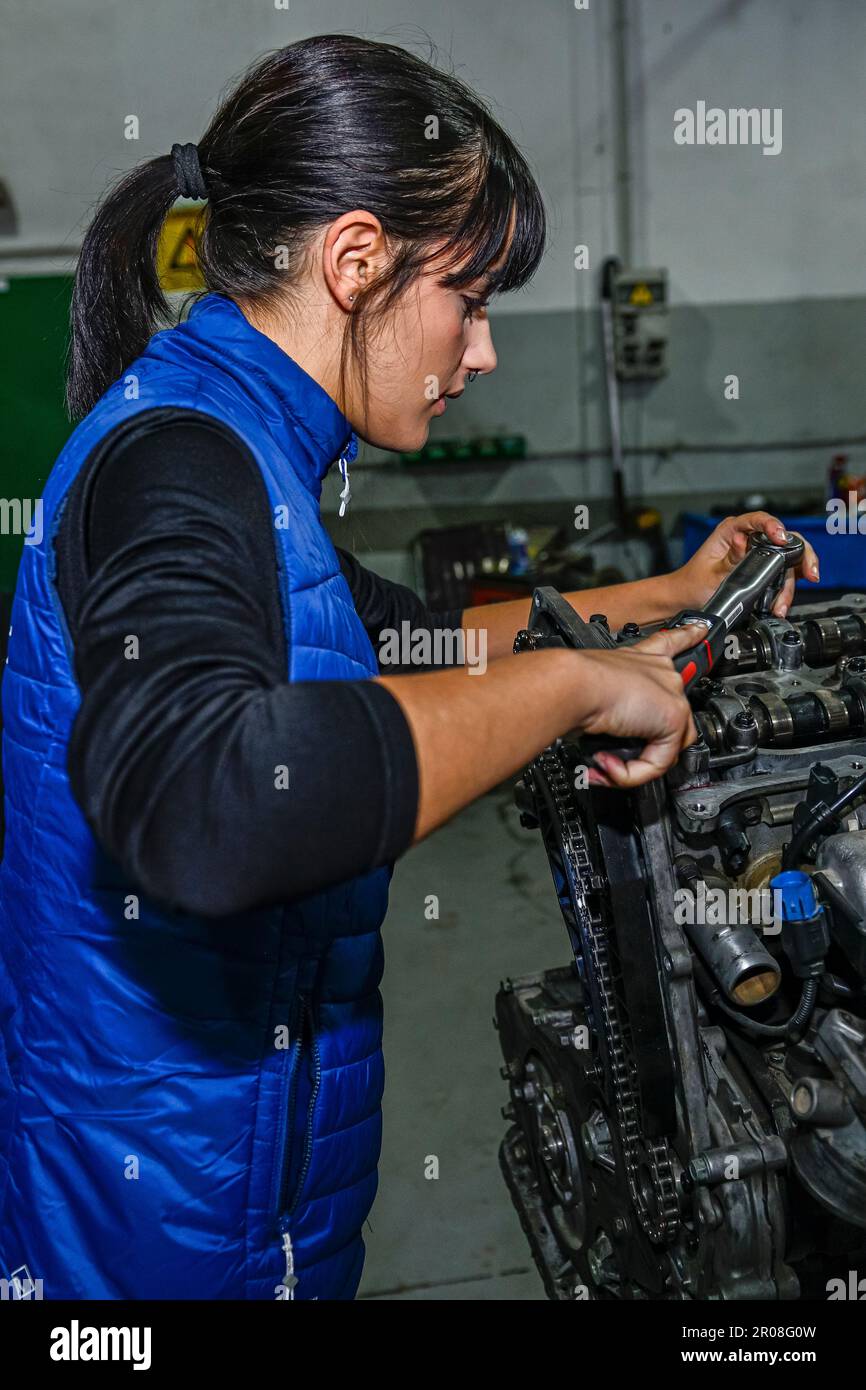 Young female mechanic, working on the repair of a car engine Stock ...