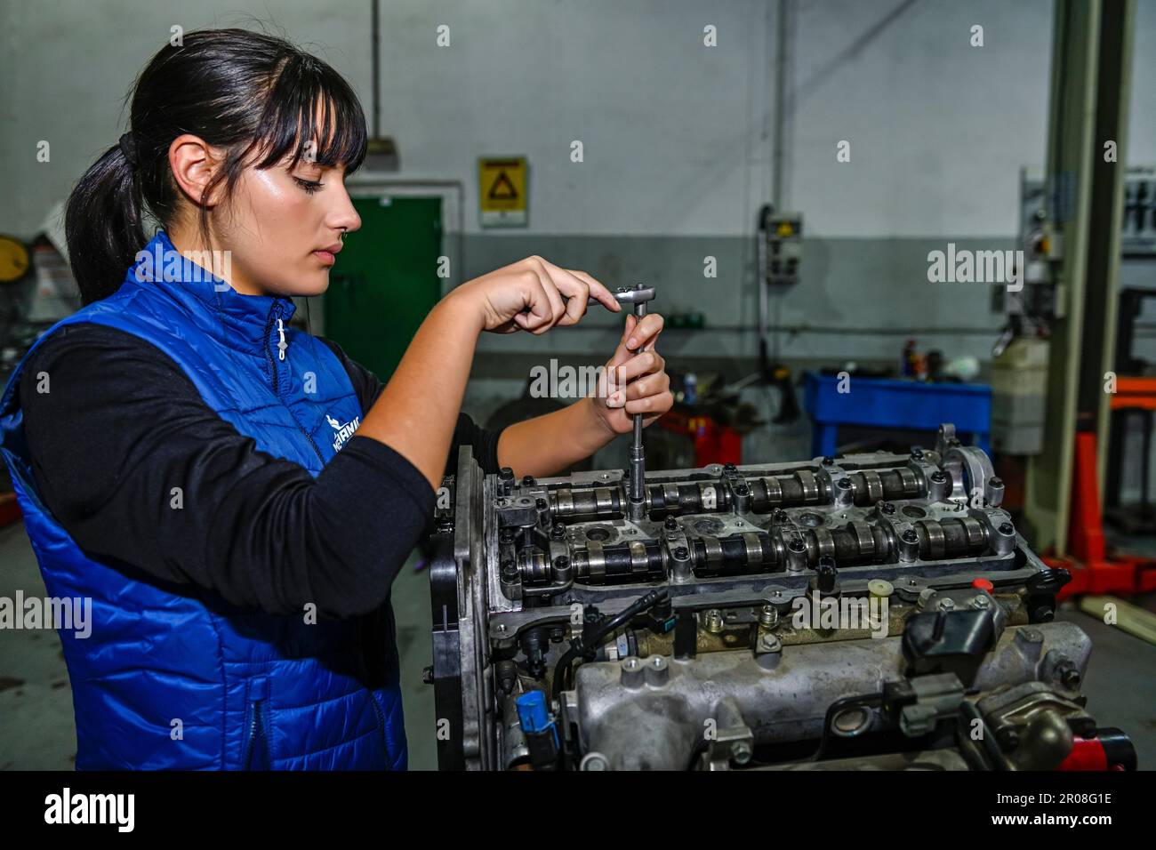 Young female mechanic, working on the repair of a car engine Stock ...