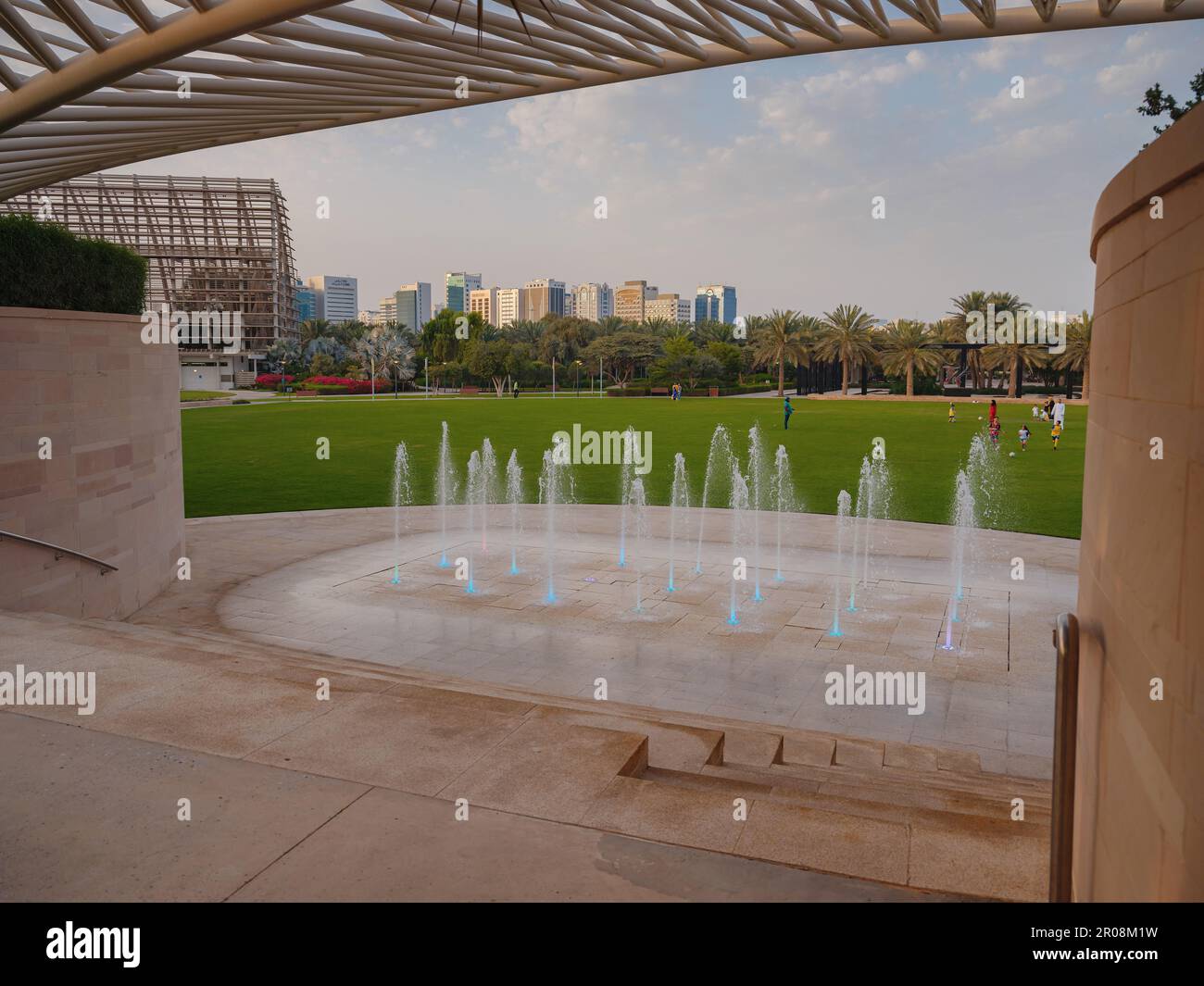 Large green evening park in the big city, Umm Al Emarat Park in Abu ...