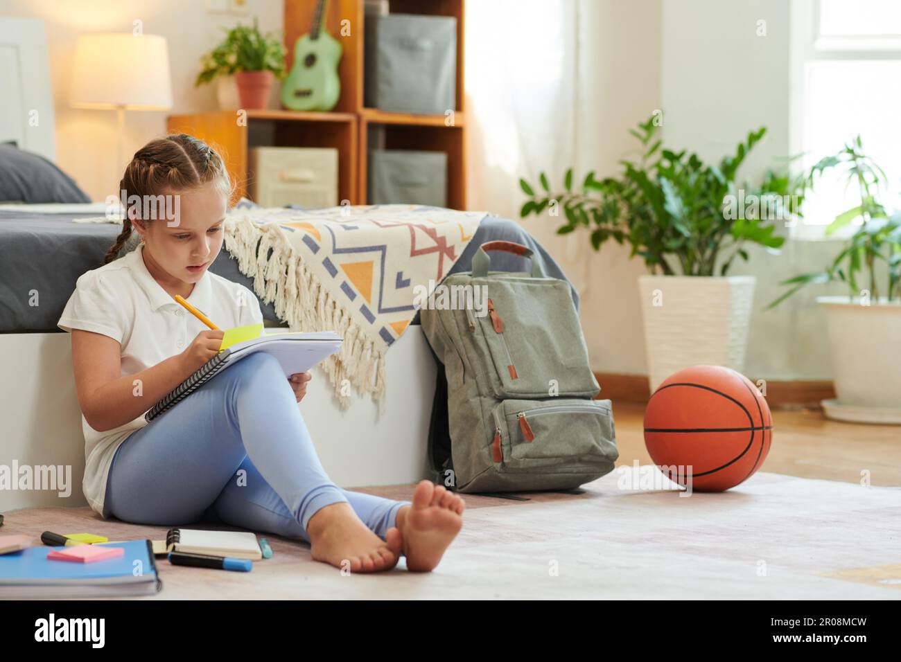 Girl sitting on basketball hi-res stock photography and images - Alamy