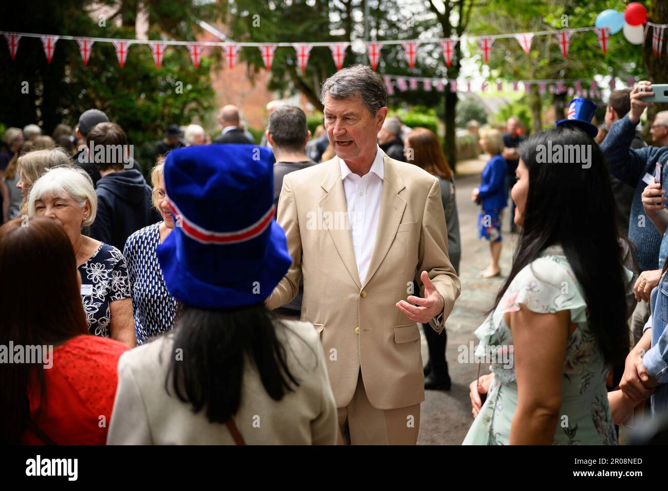 Tim Laurence speaks with residents as he joins Britain's Princess Anne ...