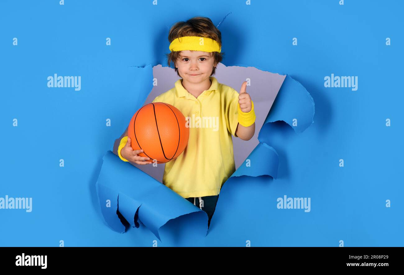Basketball training game. Smiling child with basketball ball showing ...