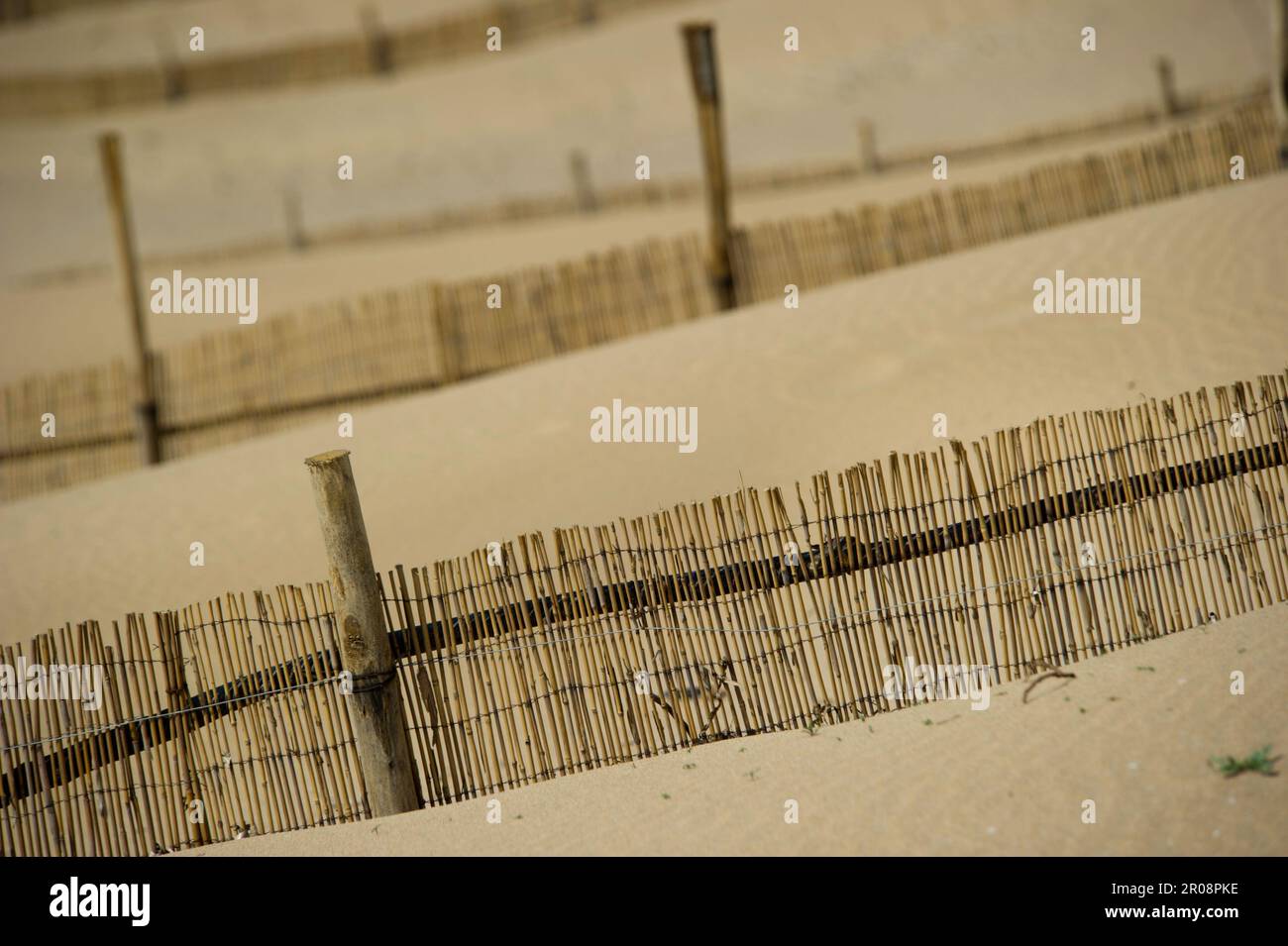 sand dunes and fence on the beach. Alghero, Sardinia, Italy Stock Photo ...
