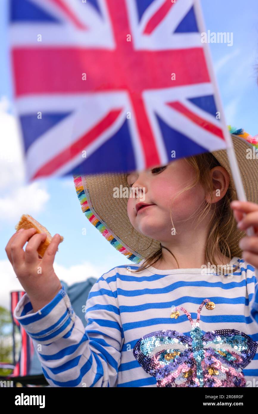 Celebration of the coronation of King Charles III. Child enjoying a ...