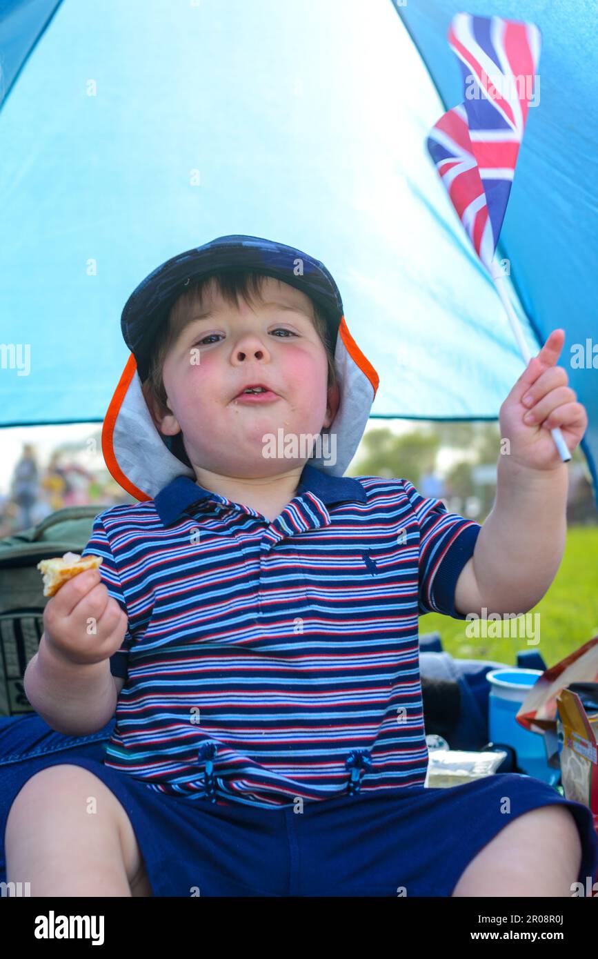 Celebration of the coronation of King Charles III. Child enjoying a ...