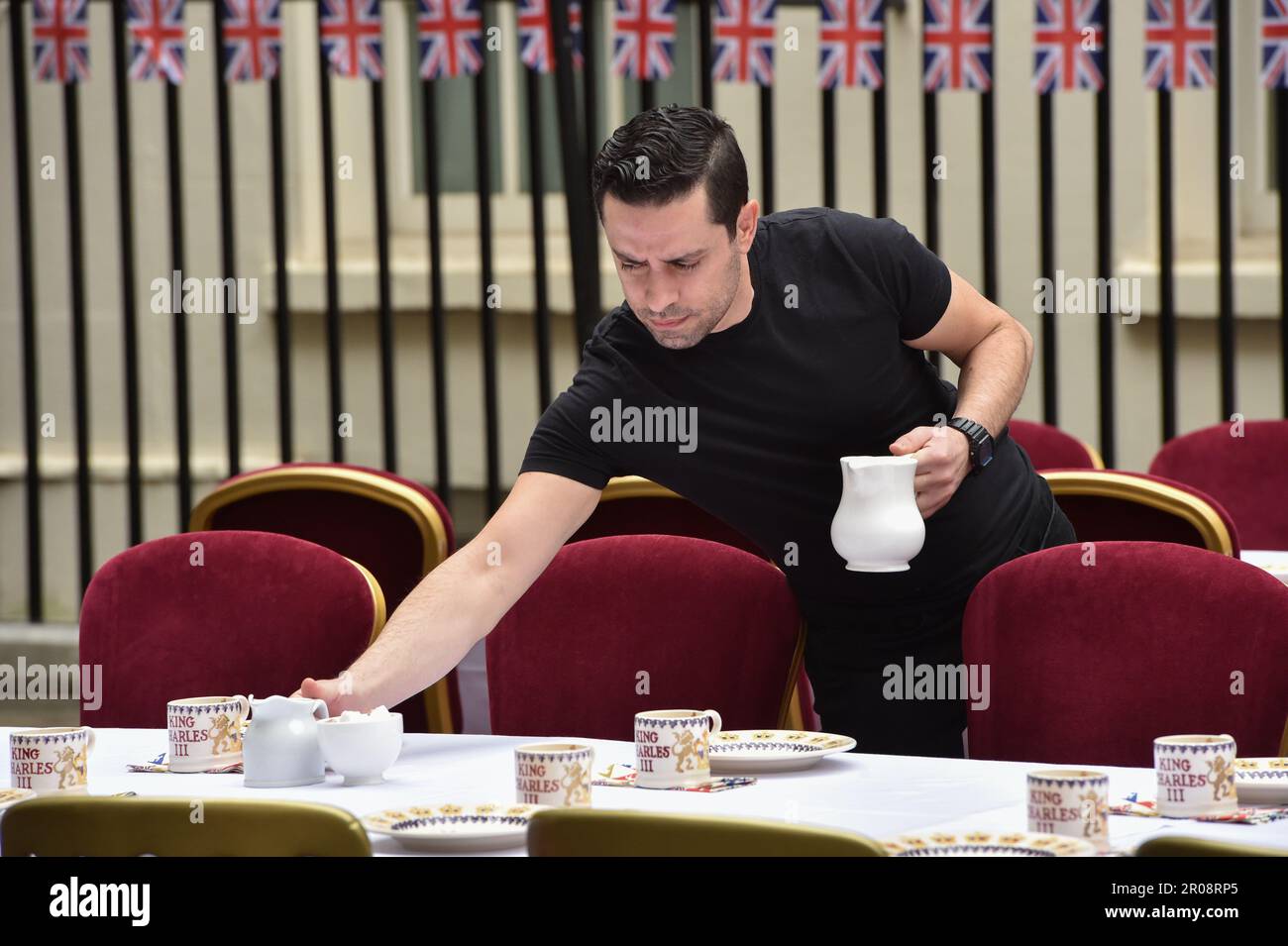 London, England, UK. 7th May, 2023. A waiter prepares the table for the ...