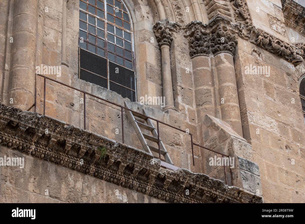 The immovable ladder which leans against a window ledge in the upper ...
