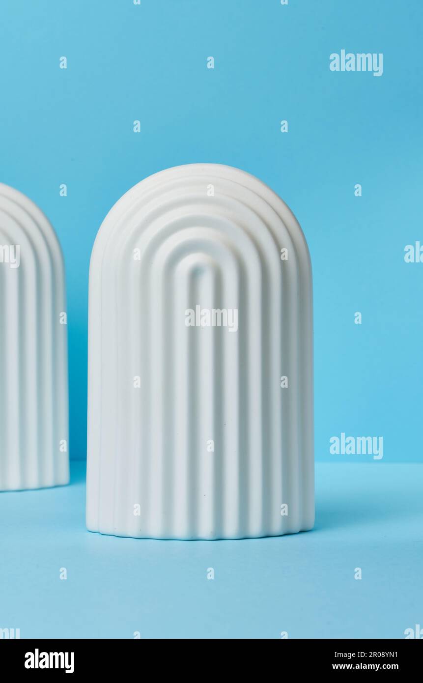 White ceramic decorative arch on a blue background, background for ...