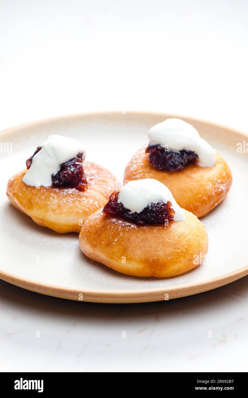 fried muffins with plum jam and sour cream Stock Photo - Alamy