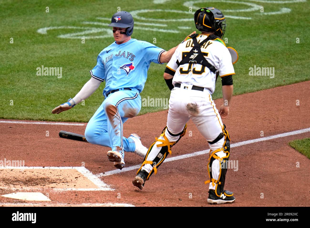 Toronto Blue Jays' Matt Chapman, left, scores on an infield sacrifice ...