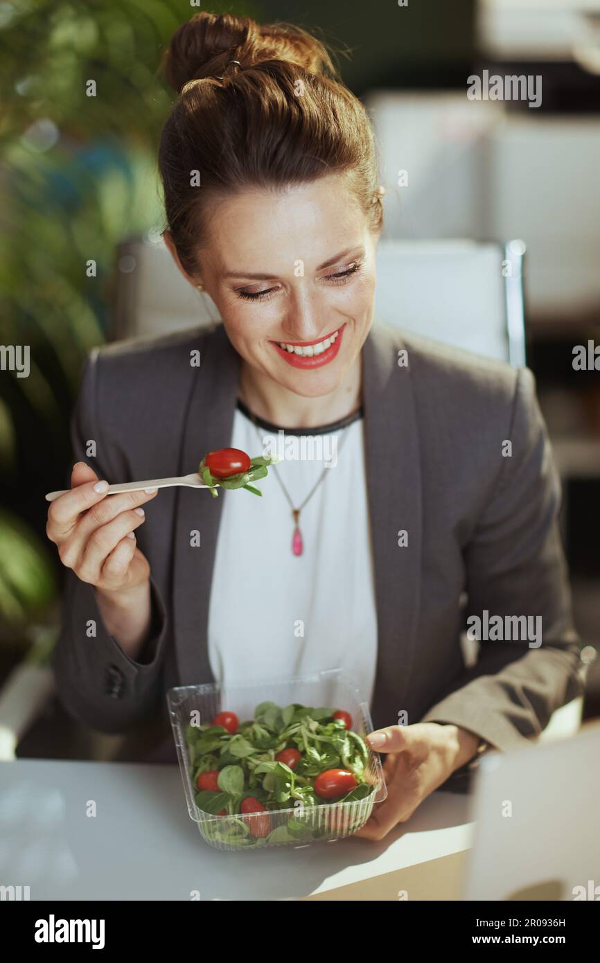 Sustainable workplace. smiling modern middle aged accountant woman in a ...
