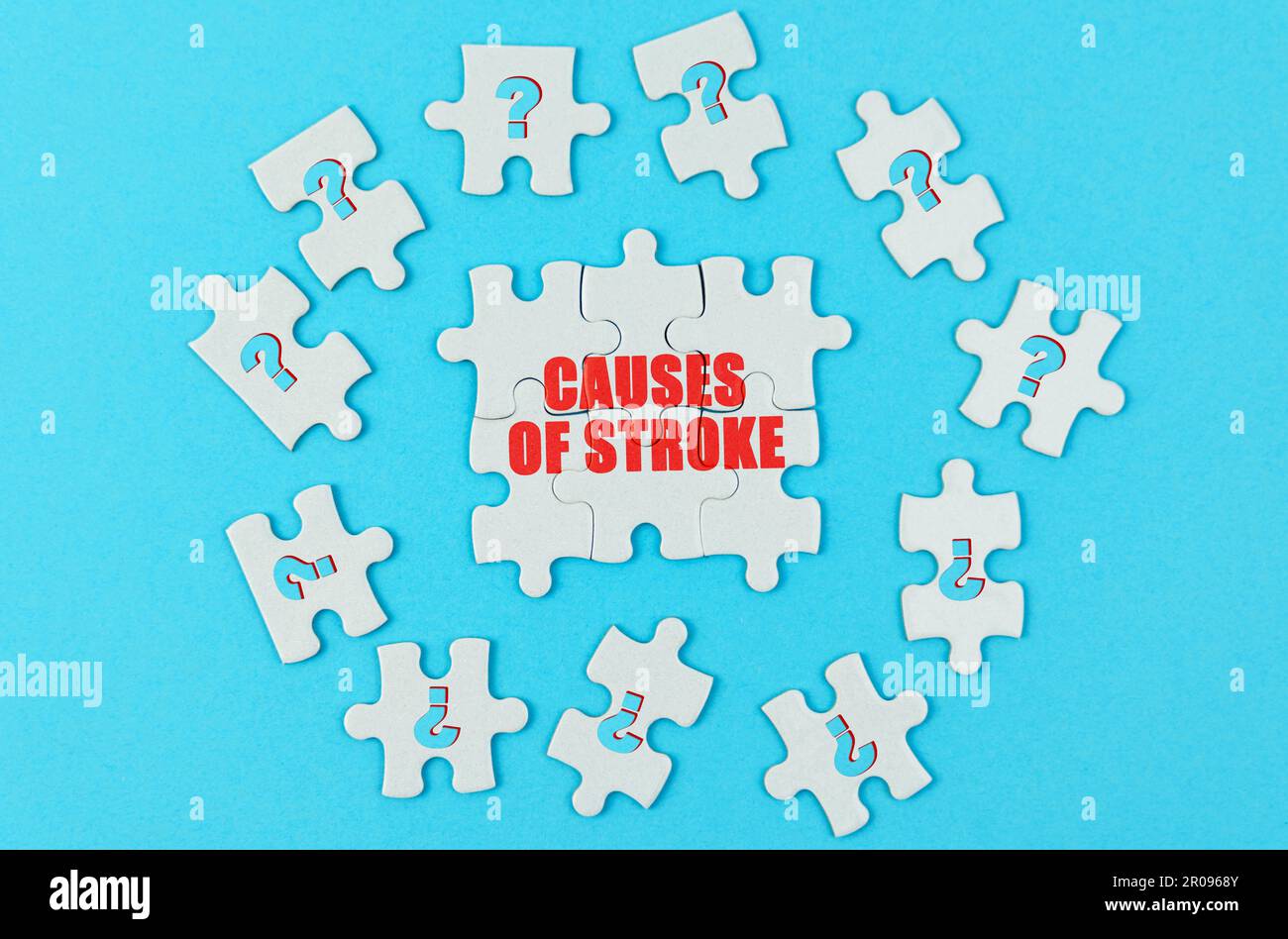 Medical concept. On a blue surface are puzzles with a question mark, in ...