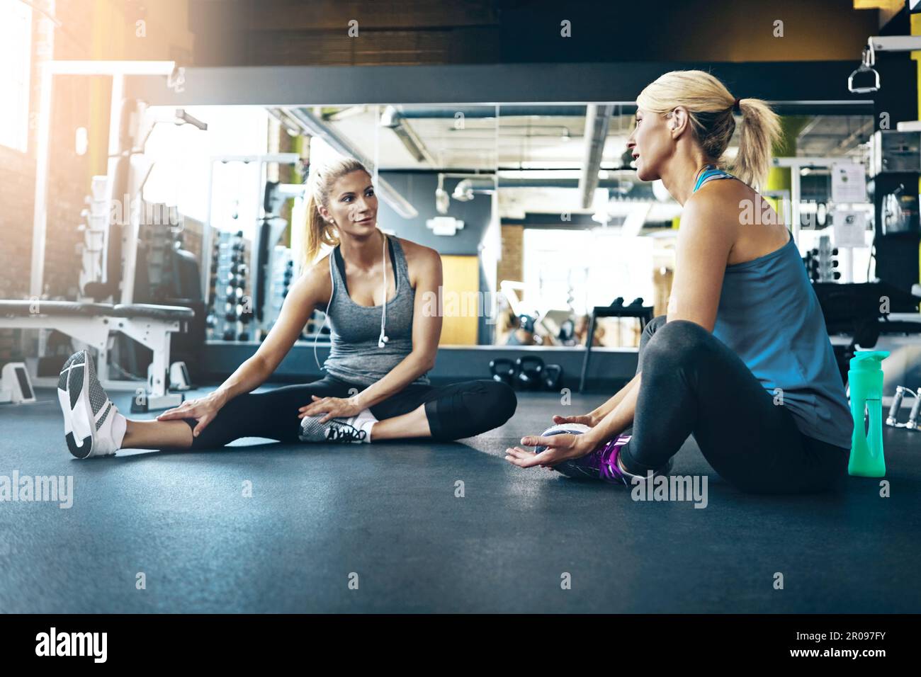 Increase your energy levels with some stretching exercises. two women ...