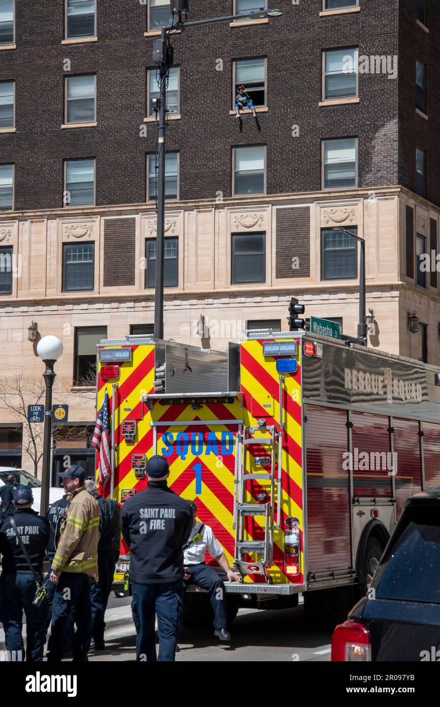 St. Paul, Minnesota. Police and emergency vehicles wait while a woman ...