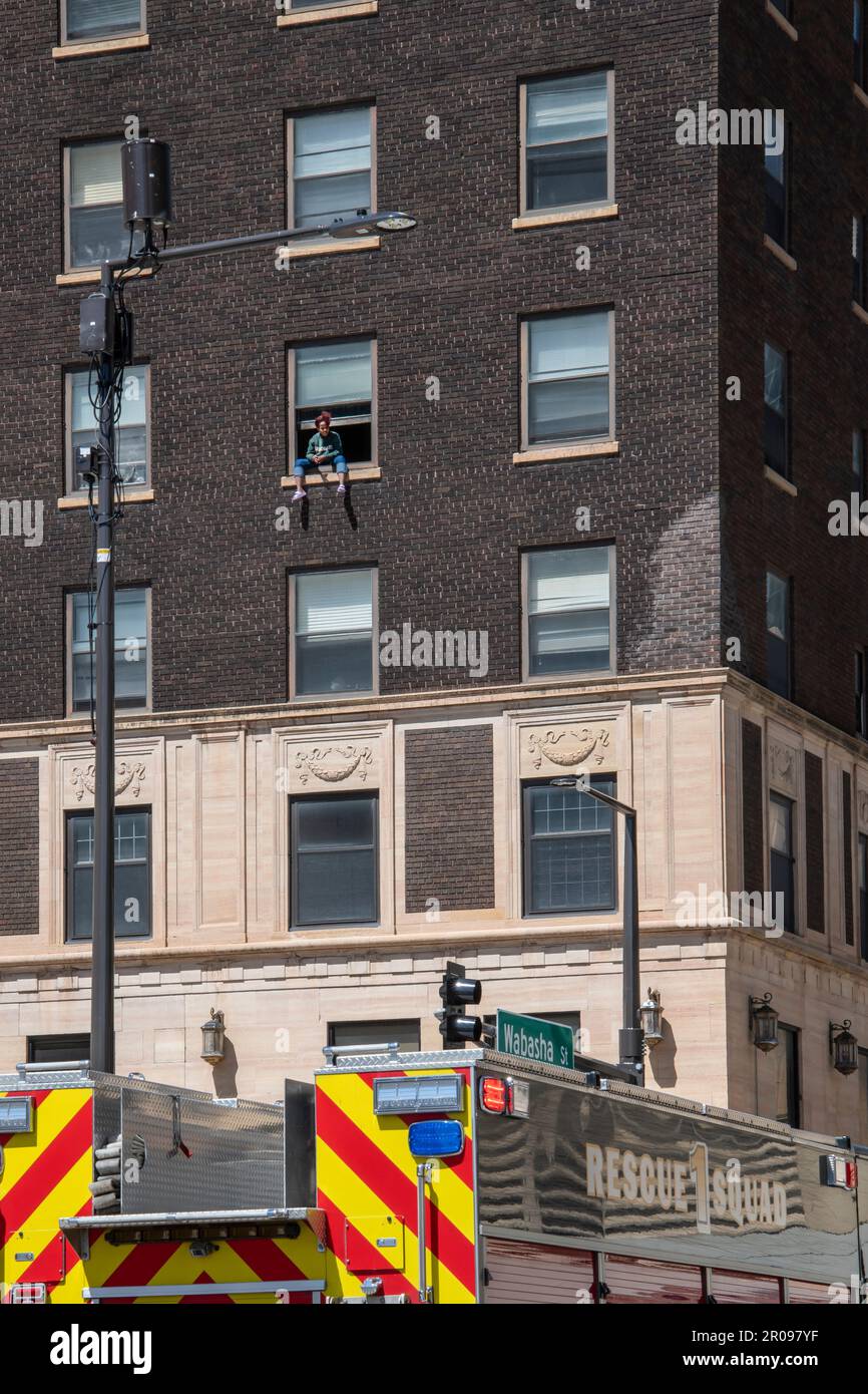 St. Paul, Minnesota. Police and emergency vehicles wait while a woman ...