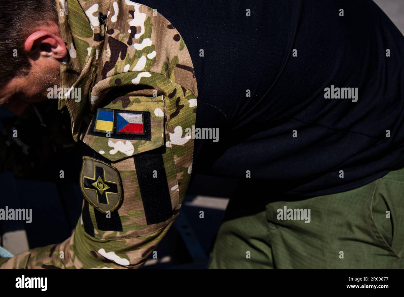 Ukrainian soldier loading a combat vehicle damaged by shrapnel from the ...