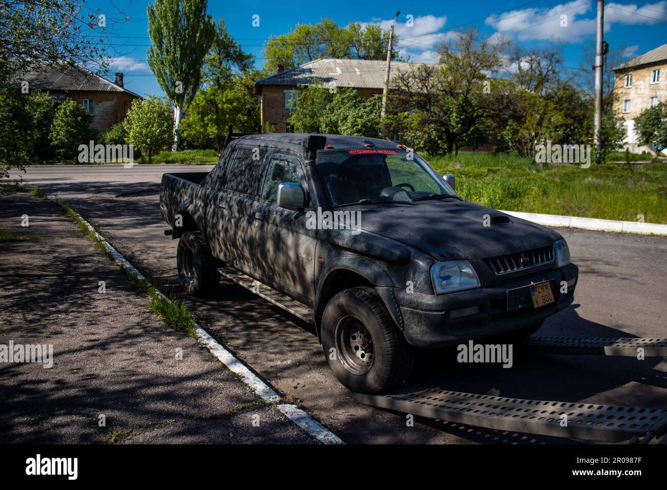 Ukrainian soldier loading a combat vehicle damaged by shrapnel from the ...