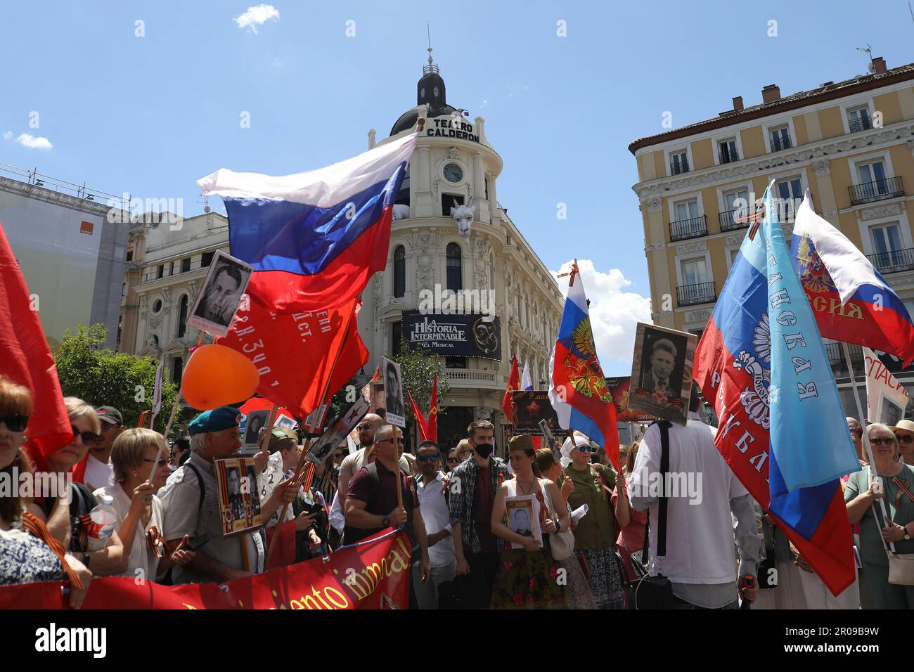 A group of demonstrators hold flags of the former Soviet Union as well ...