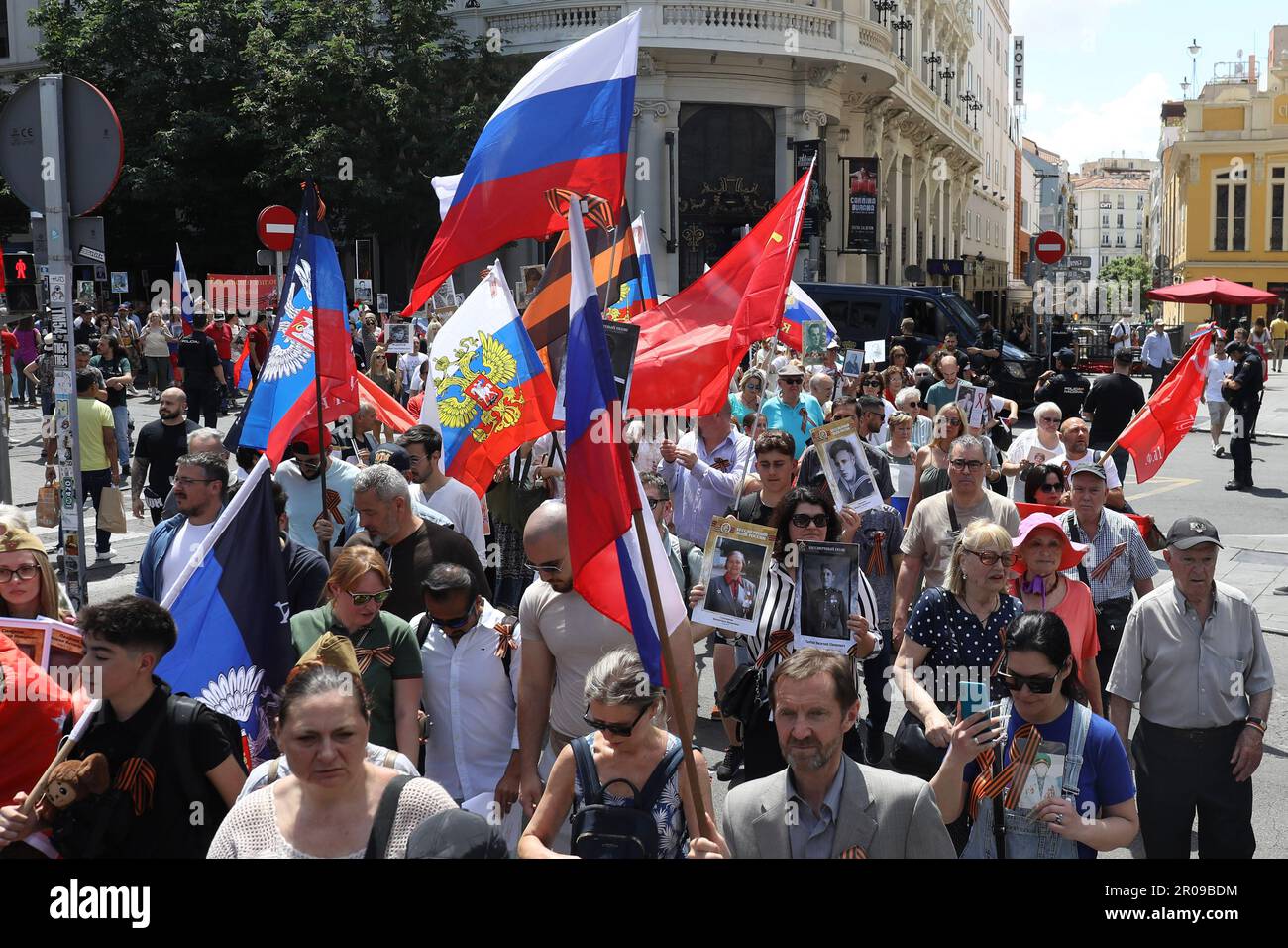 A group of demonstrators hold flags of the former Soviet Union as well ...