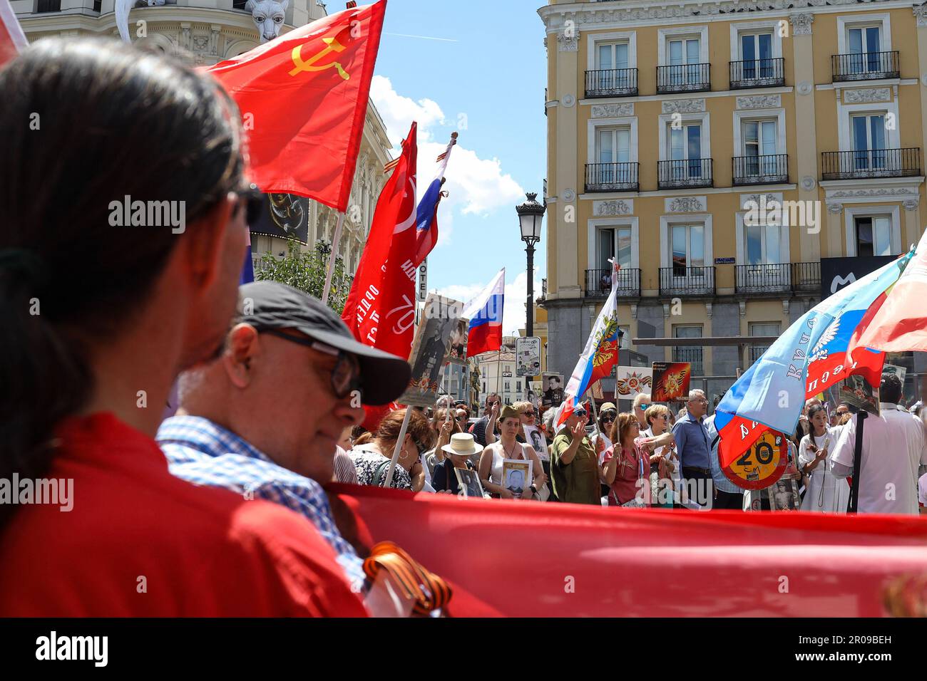 A group of demonstrators hold flags of the former Soviet Union as well ...