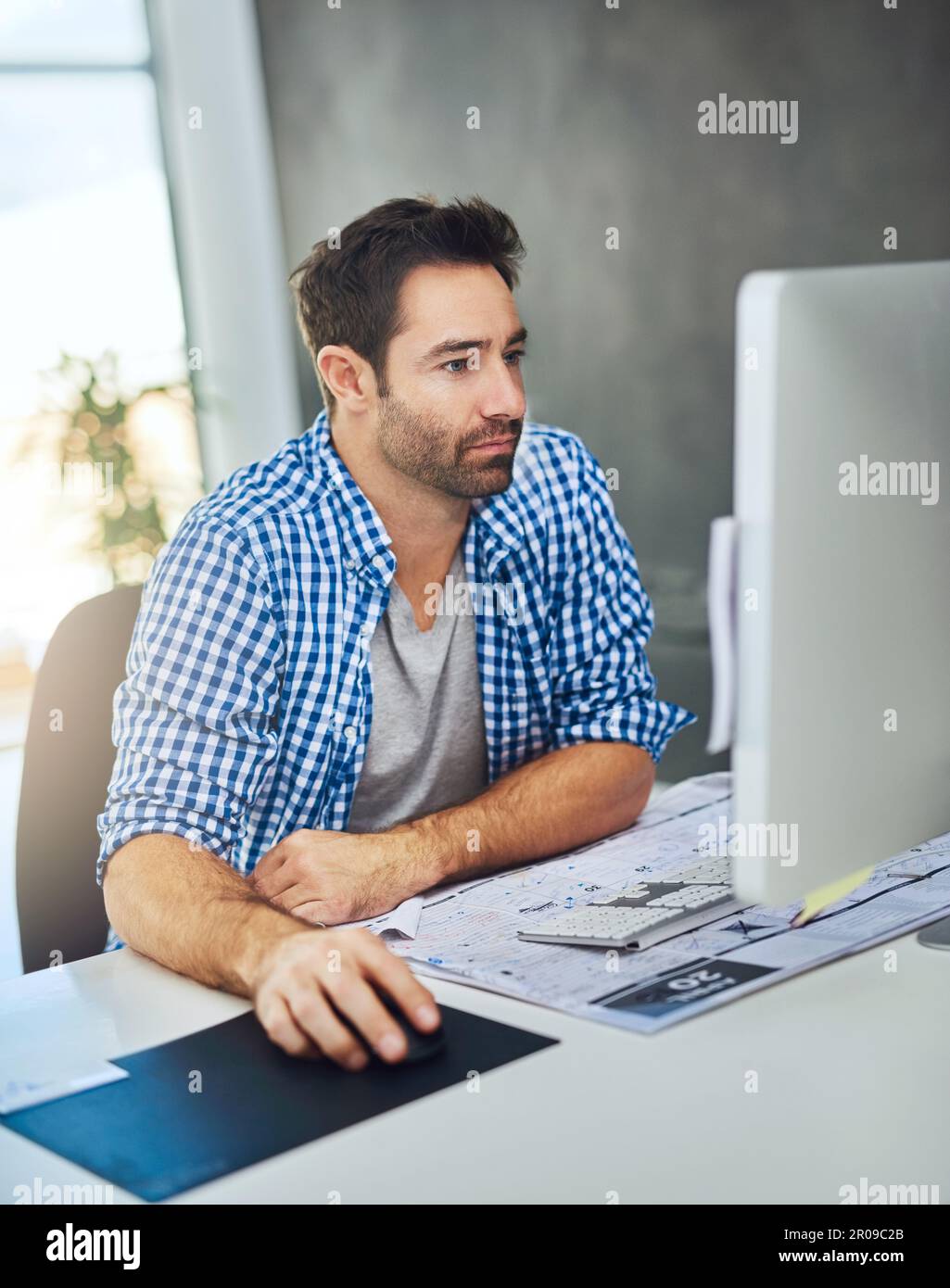 Developing his business formulae. a businessman working on a computer ...
