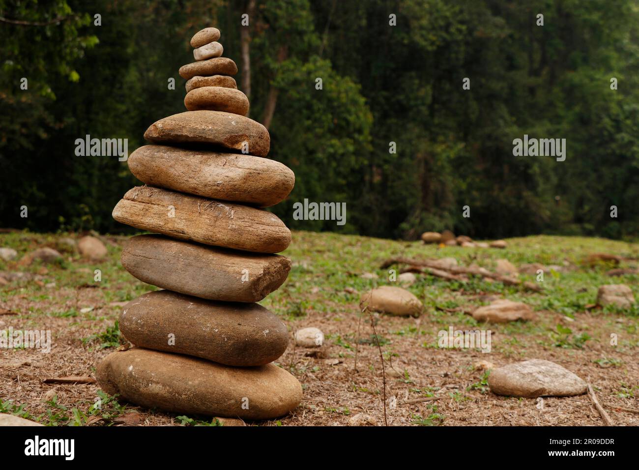 The pebbles stones are stacked in a pyramid against the natural ...