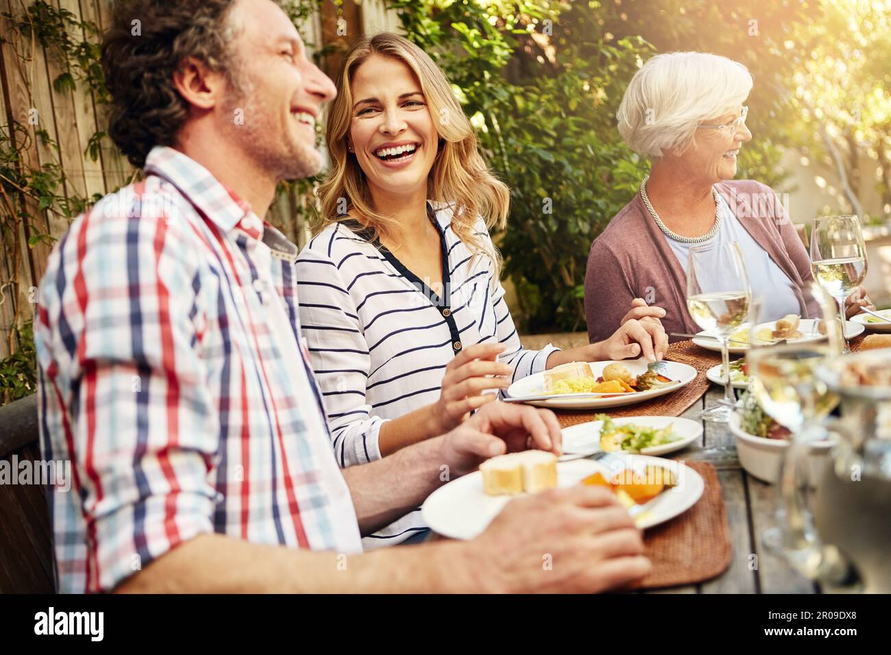 Good food, great life. a family eating lunch together outdoors Stock ...