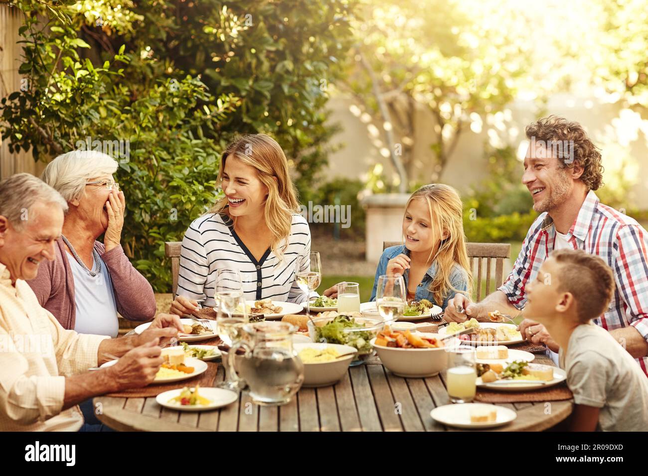 This is what familys all about. a family eating lunch together outdoors ...