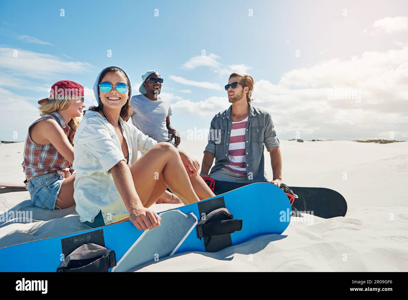 Theyre avid sand boarders. a group of young friends sandboarding in the ...