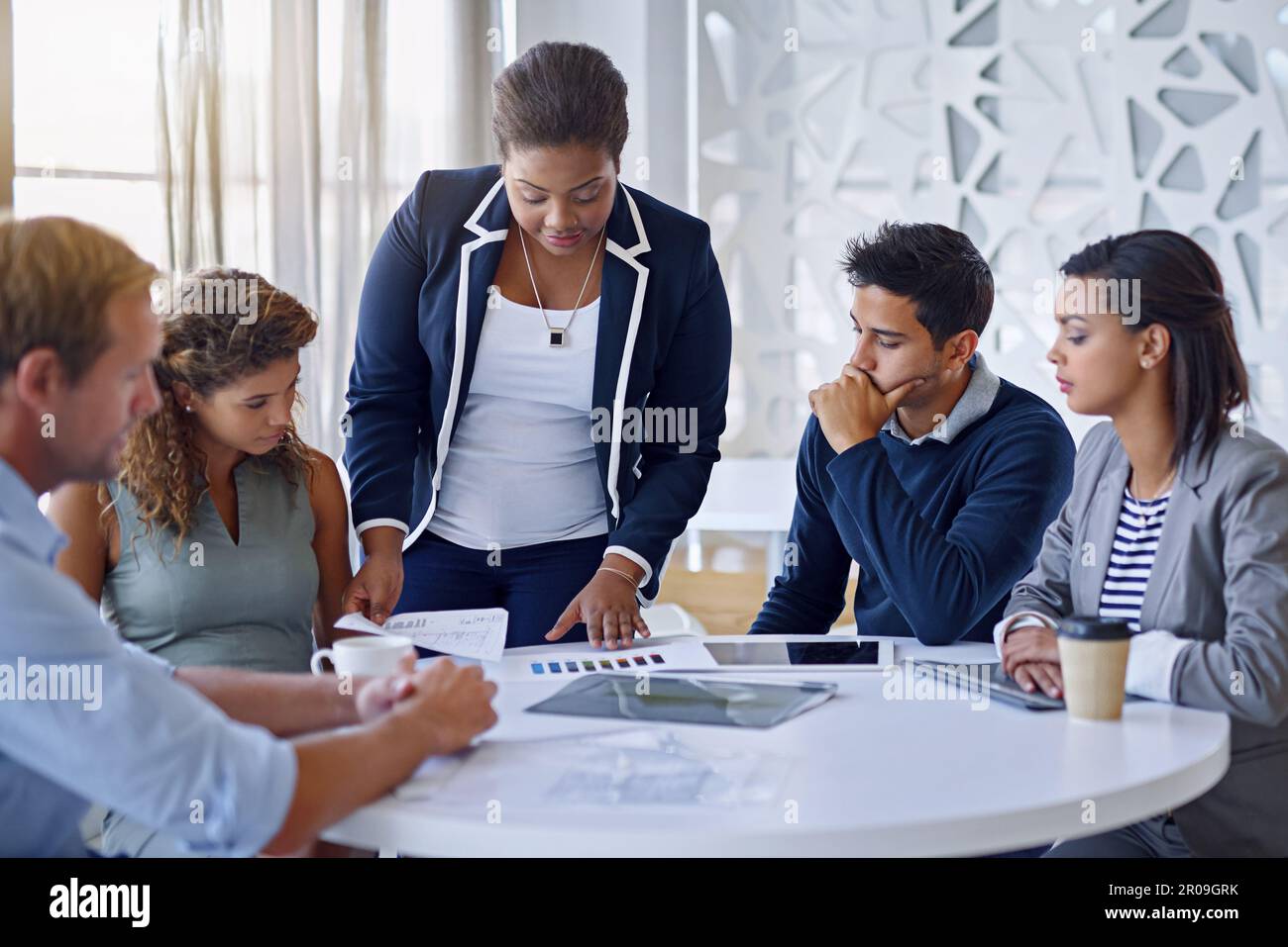 Sorting out facts and figures. a group of colleagues working together ...