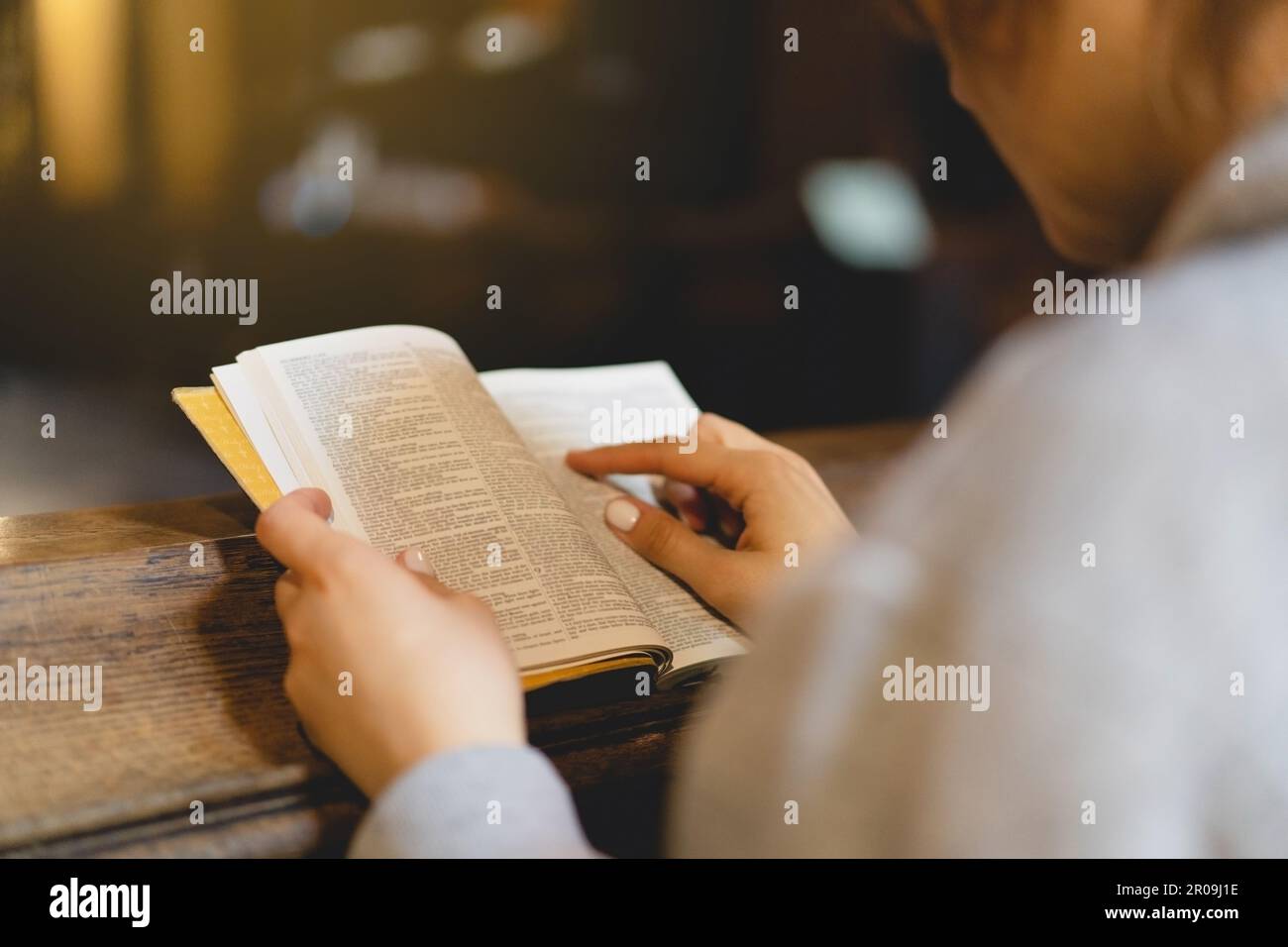 Christian woman reading bible in an ancient Catholic temple. Reading ...