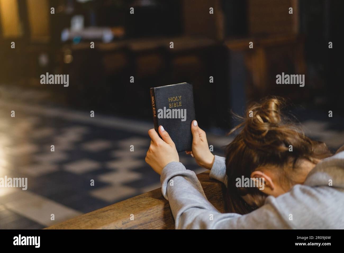 Christian woman reading bible in an ancient Catholic temple. Reading ...
