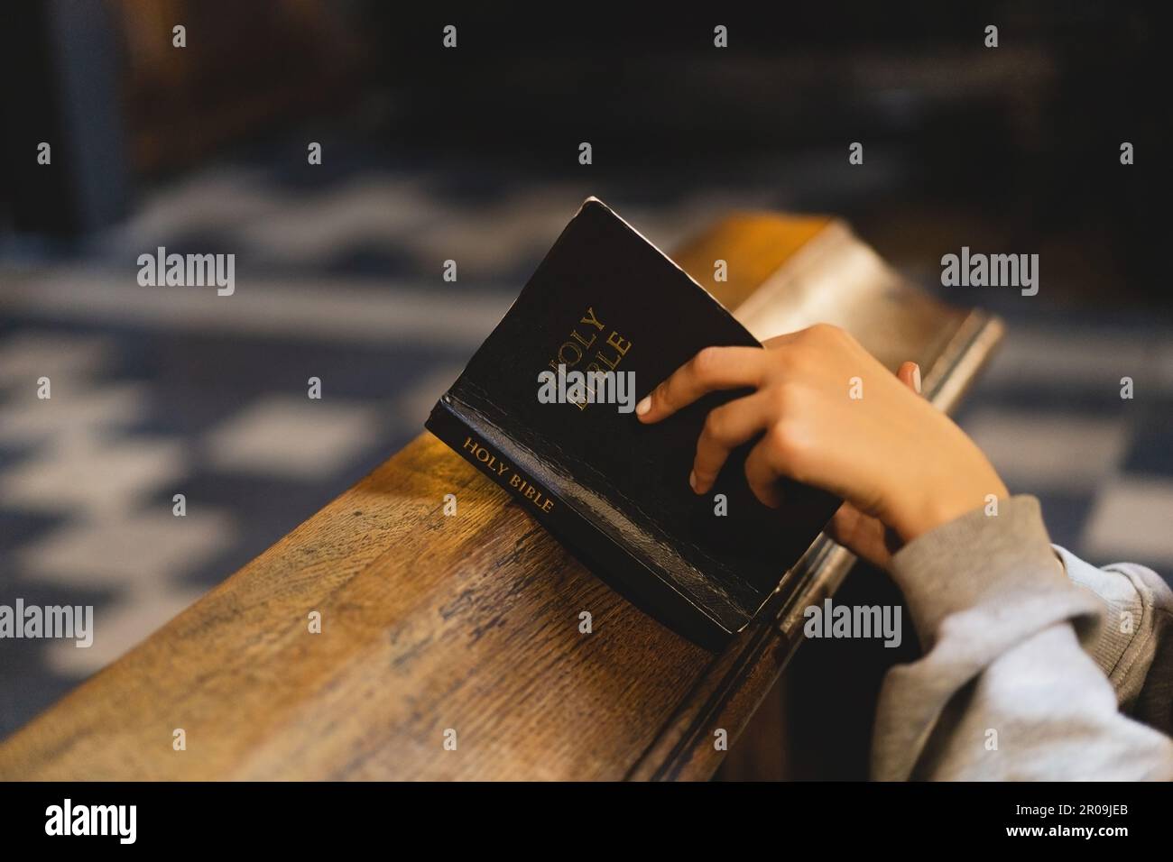 Christian woman reading bible in an ancient Catholic temple. Reading ...